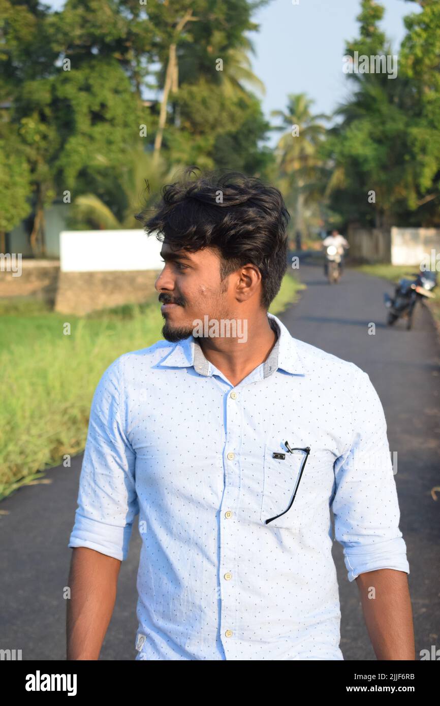 Indian man walking on a road and posing for photo Stock Photo - Alamy