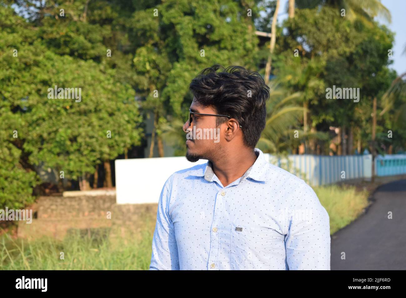 Indian man walking on a road and posing for photo Stock Photo - Alamy