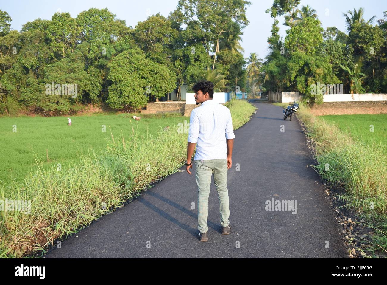 Indian man walking on a road and posing for photo Stock Photo - Alamy