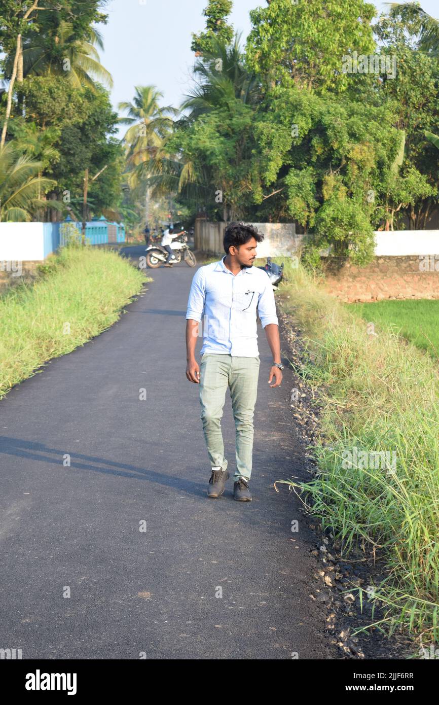 Indian man walking on a road and posing for photo Stock Photo - Alamy