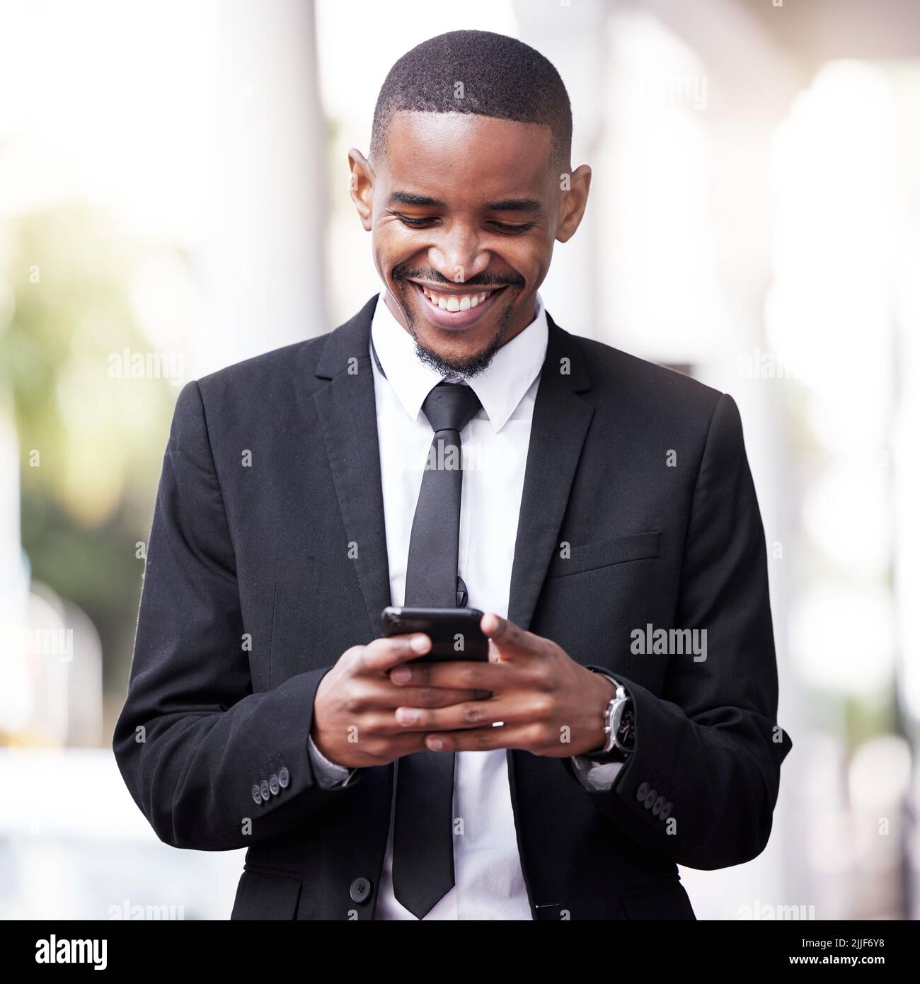 Time to make the call. a handsome young businessman checking his ...