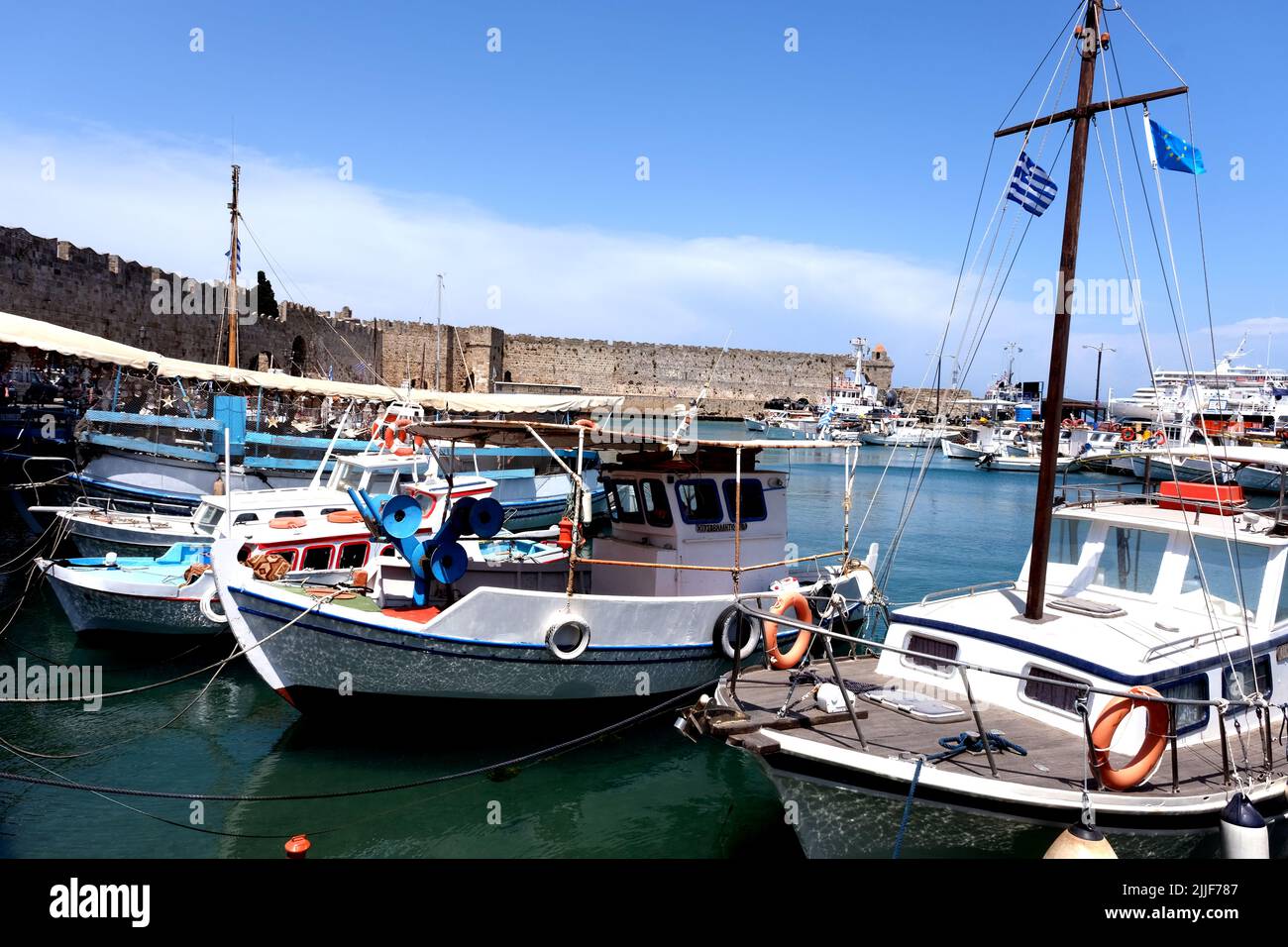 Boats moored in Mandraki Harbour on the island of Rhodes in Greece ...
