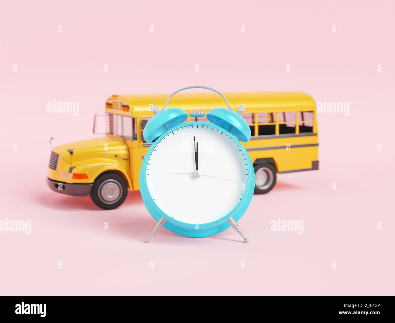 Blue alarm clock placed near toy of yellow school bus on yellow ...