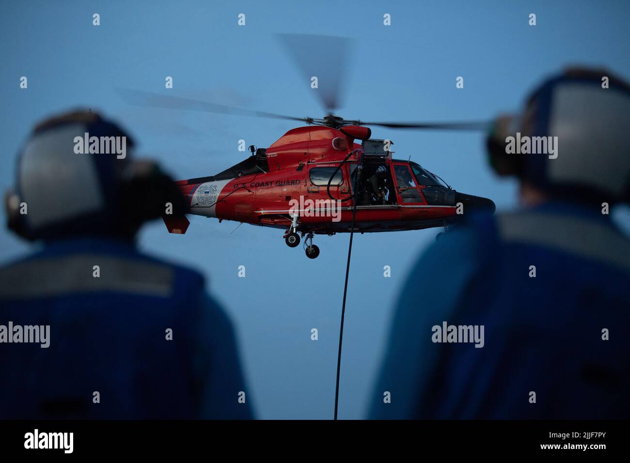 Two members from U.S. Coast Guard Cutter Bear (WMEC 901), look upward ...