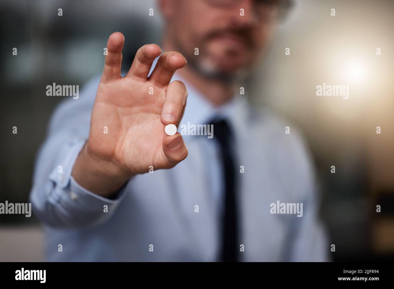 Quick and easy pain relief. an unrecognizable businessman holding a ...