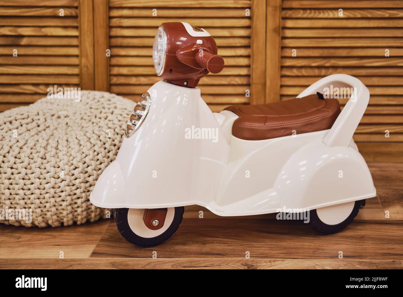 Plastic children motorcycle riding in the playroom, toy brown moped for ...