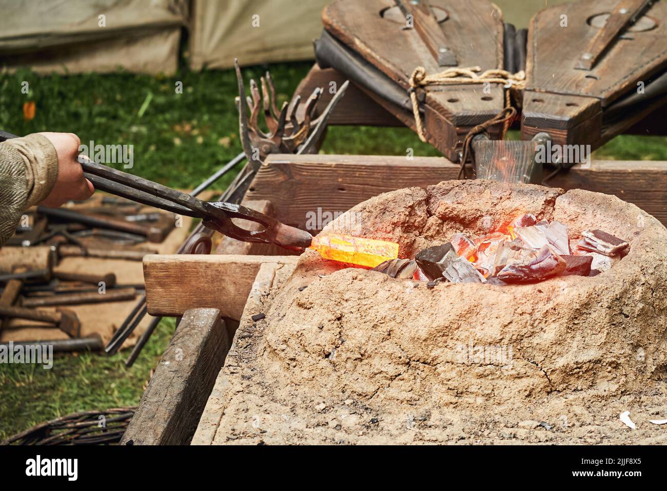 Work of a medieval blacksmith for the manufacture of metal products ...