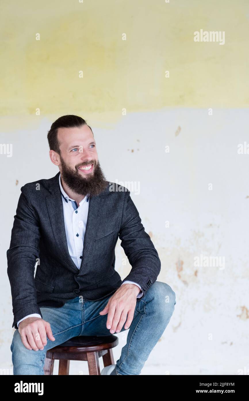 business man smile sitting shabby wall background Stock Photo - Alamy