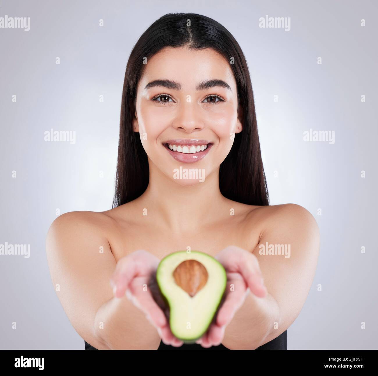 Avocados are filled with natural oils that moisturise your skin. Studio portrait of an ...