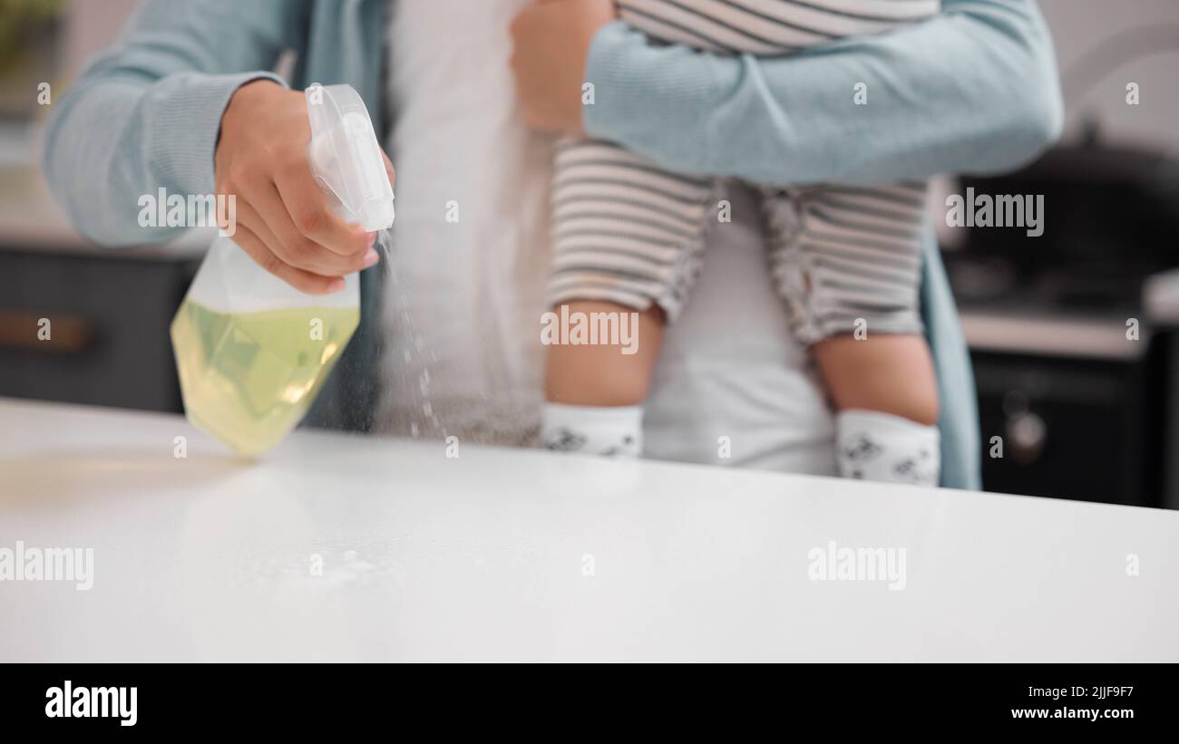 Keeping myself and my child safe. a mother cleaning her kitchen counter ...