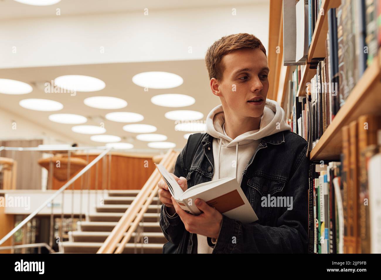 Male teenager reading book hi-res stock photography and images - Alamy