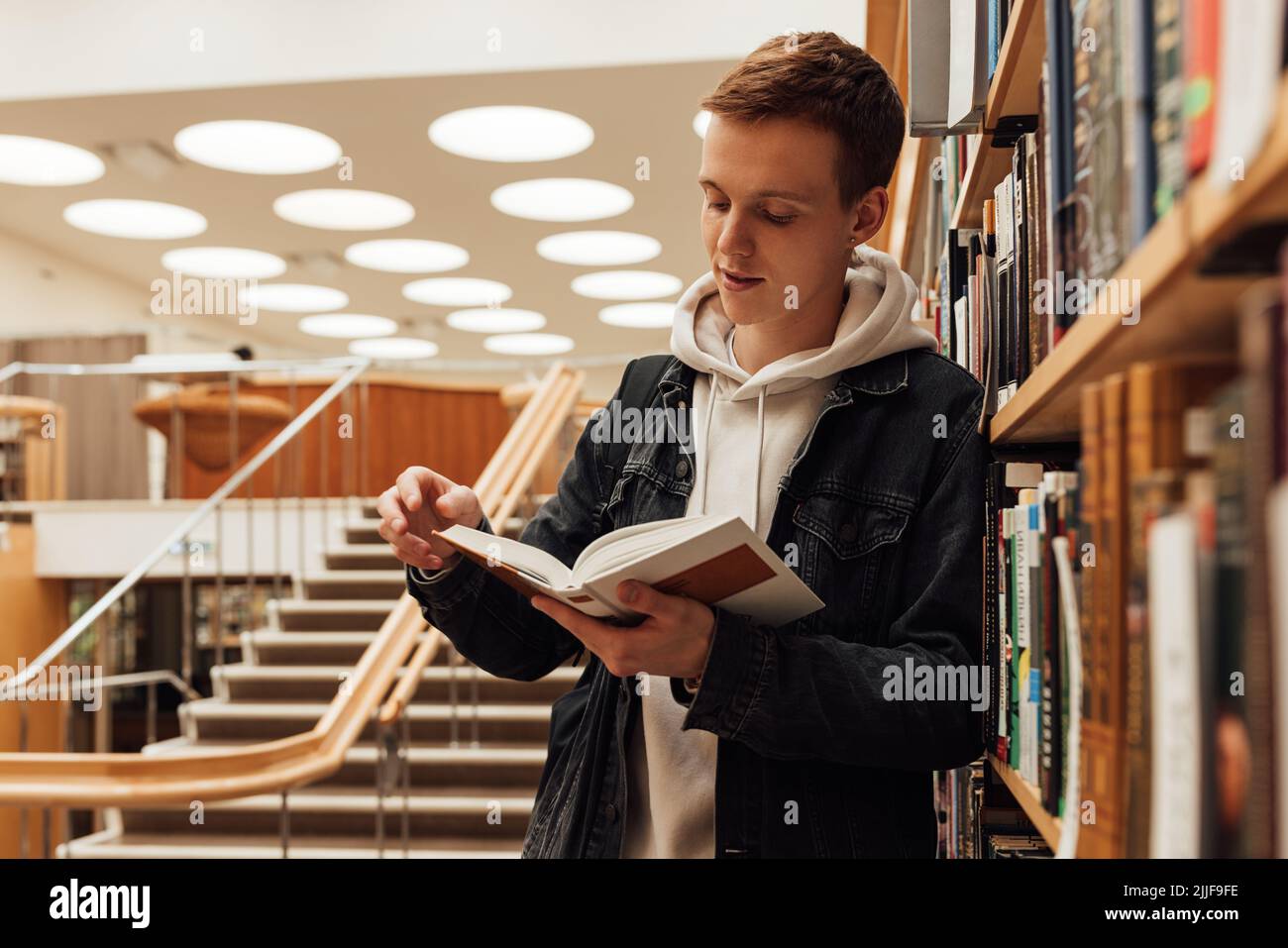 Student holding a book hi-res stock photography and images - Alamy