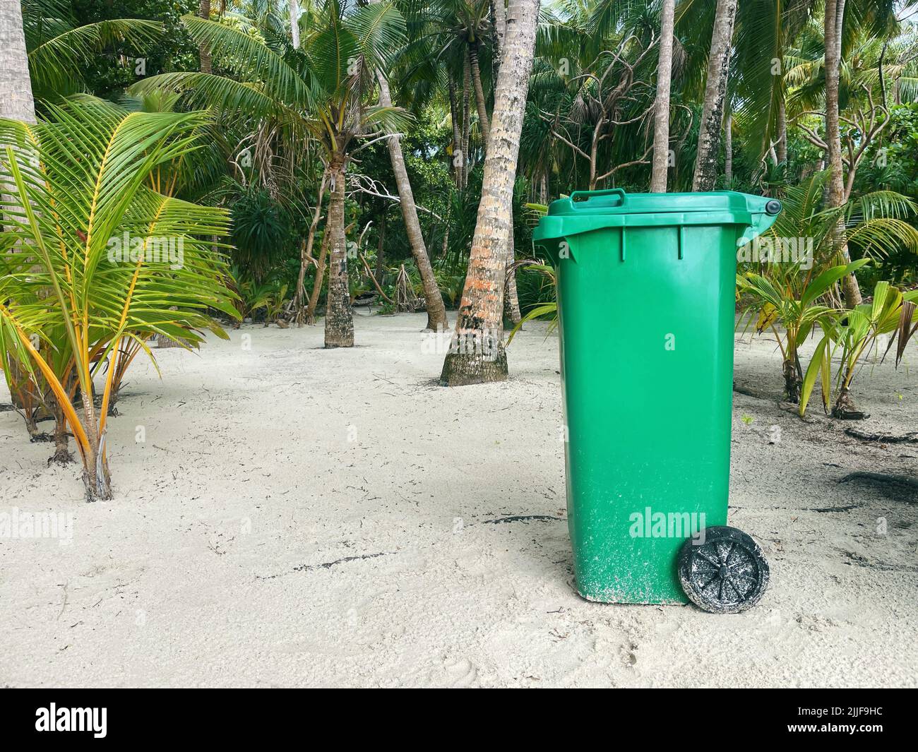 Green garbage bin on a tropical beach Stock Photo - Alamy