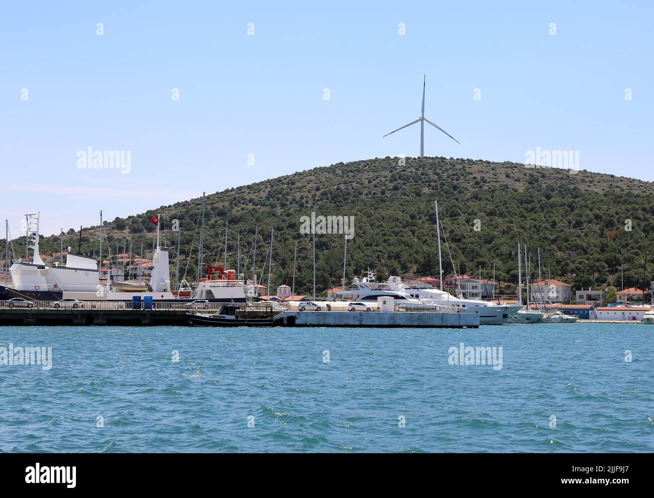 Boats and Ships at Cesme Port and Wind Turbine on the Hill in Cesme ...