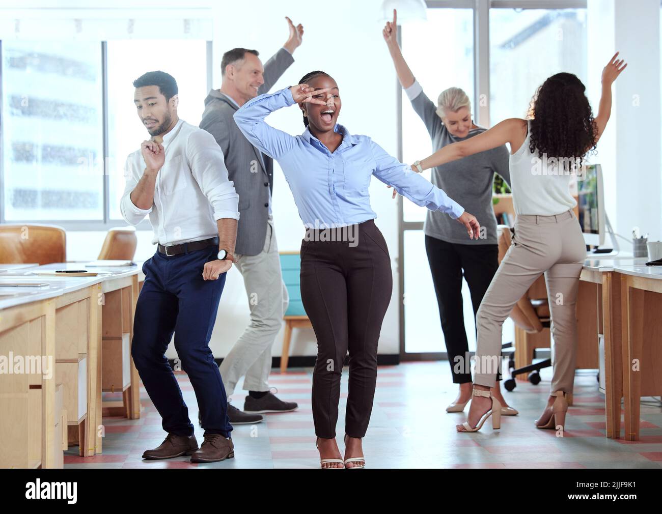 Dance break, anyone. a group of businesspeople dancing in an office at ...