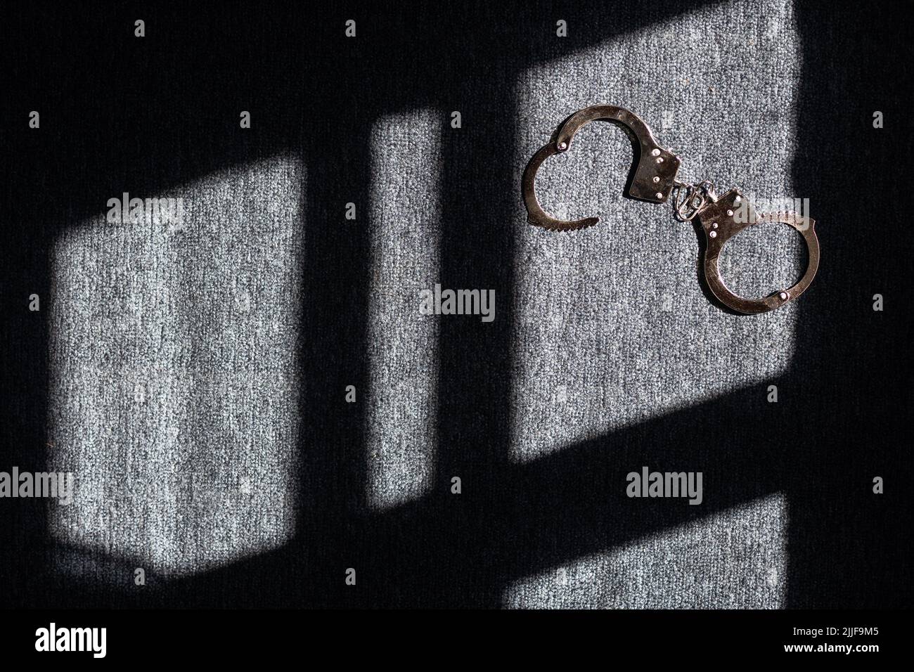 Classic chain handcuffs on black background Stock Photo - Alamy