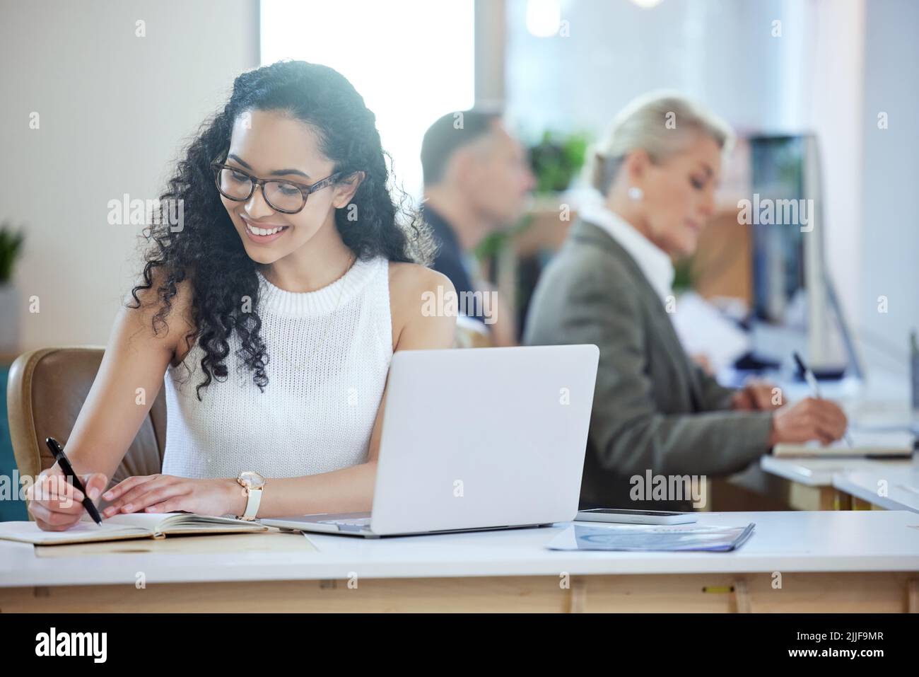 Shes got a full diary. a young businesswoman writing in a diary in an ...