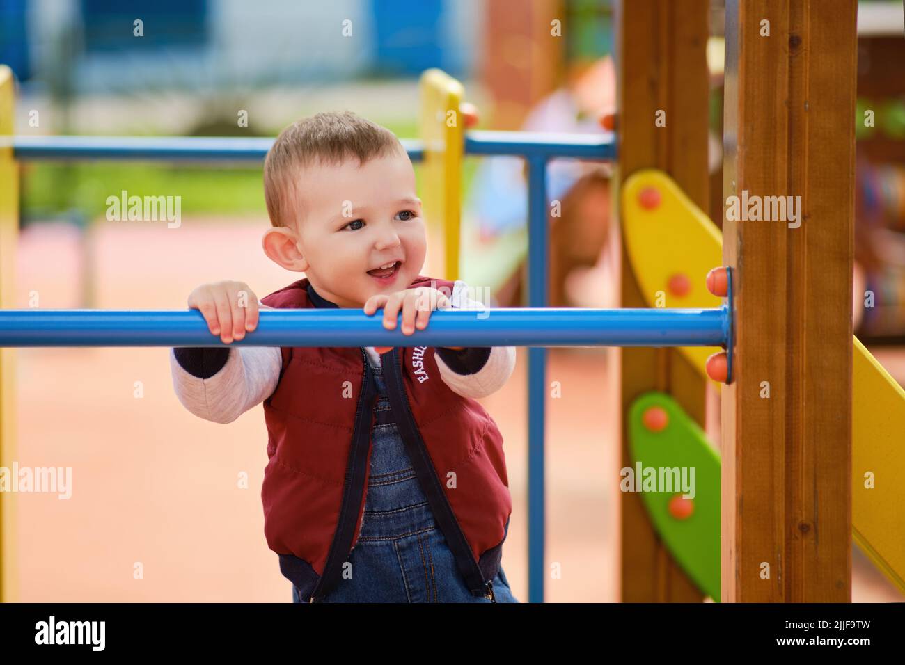Happy toddler baby boy on the playground, smiling child aged one year ...