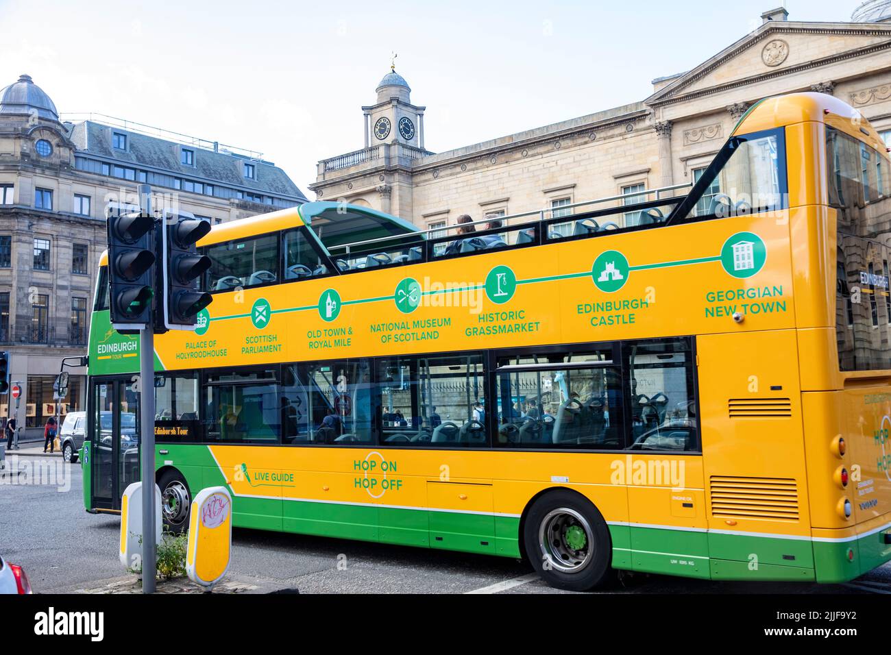 City of Edinburgh Scotland, people on a green and yellow open top ...