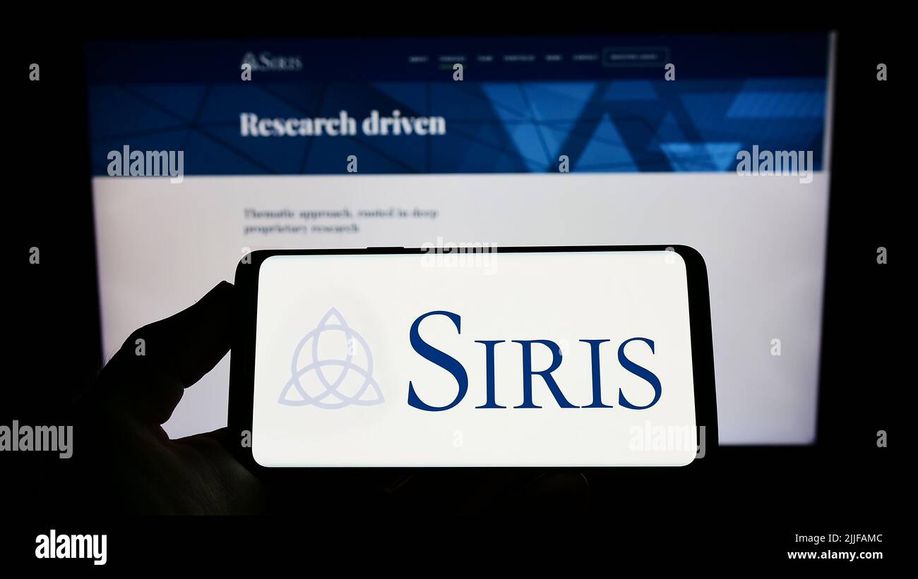 Person holding smartphone with logo of US investment company Siris ...