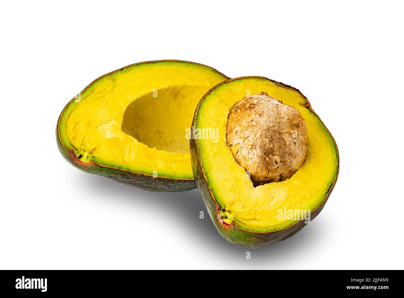 Half ripe avocado fruit with seed isolated on white background with ...