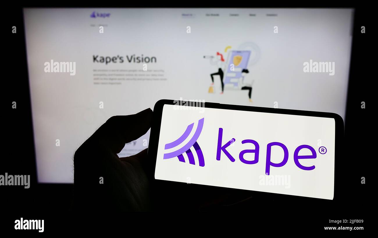 Person holding cellphone with logo of cybersecurity company Kape ...