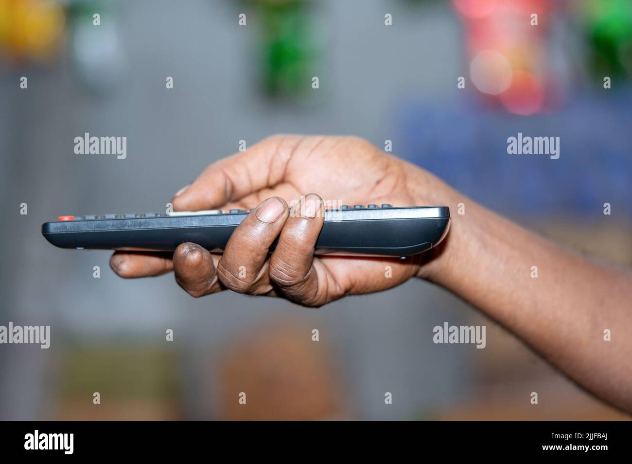 Person holding using tv remote hi-res stock photography and images - Alamy