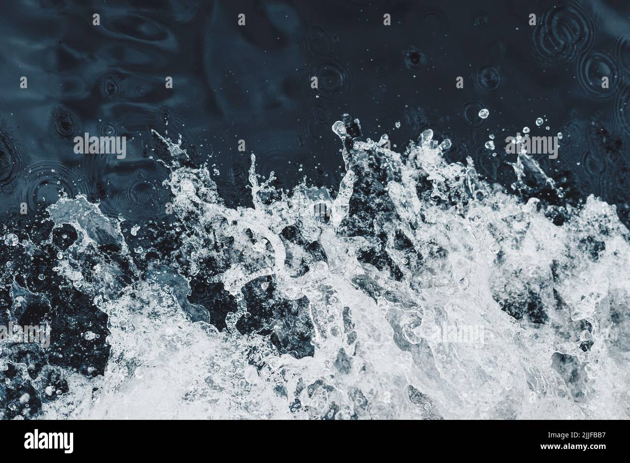A top view of a foamy wave splashing over a water surface Stock Photo ...