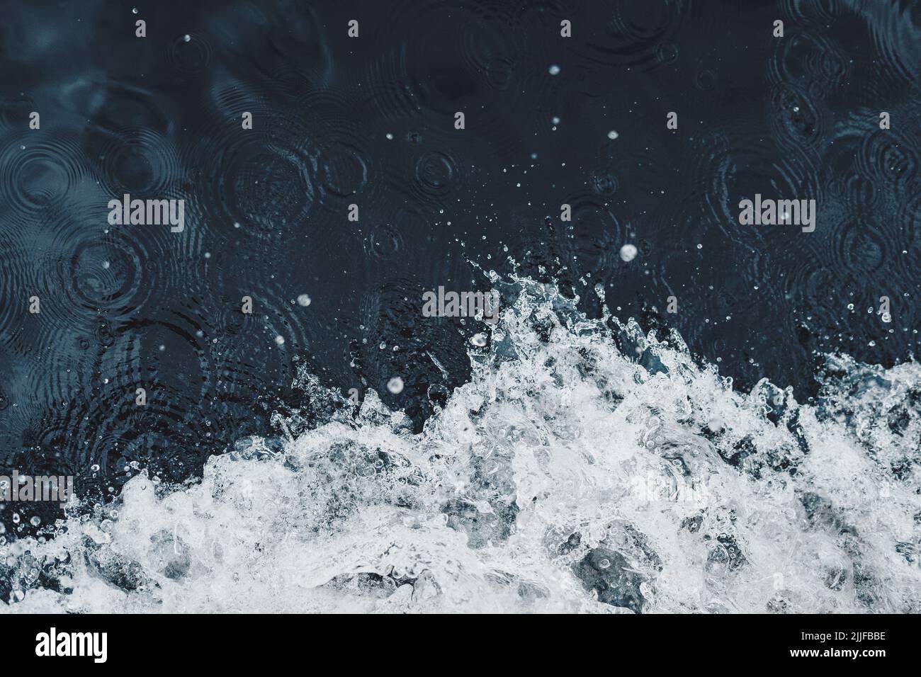A top view of a foamy wave splashing over a water surface Stock Photo ...