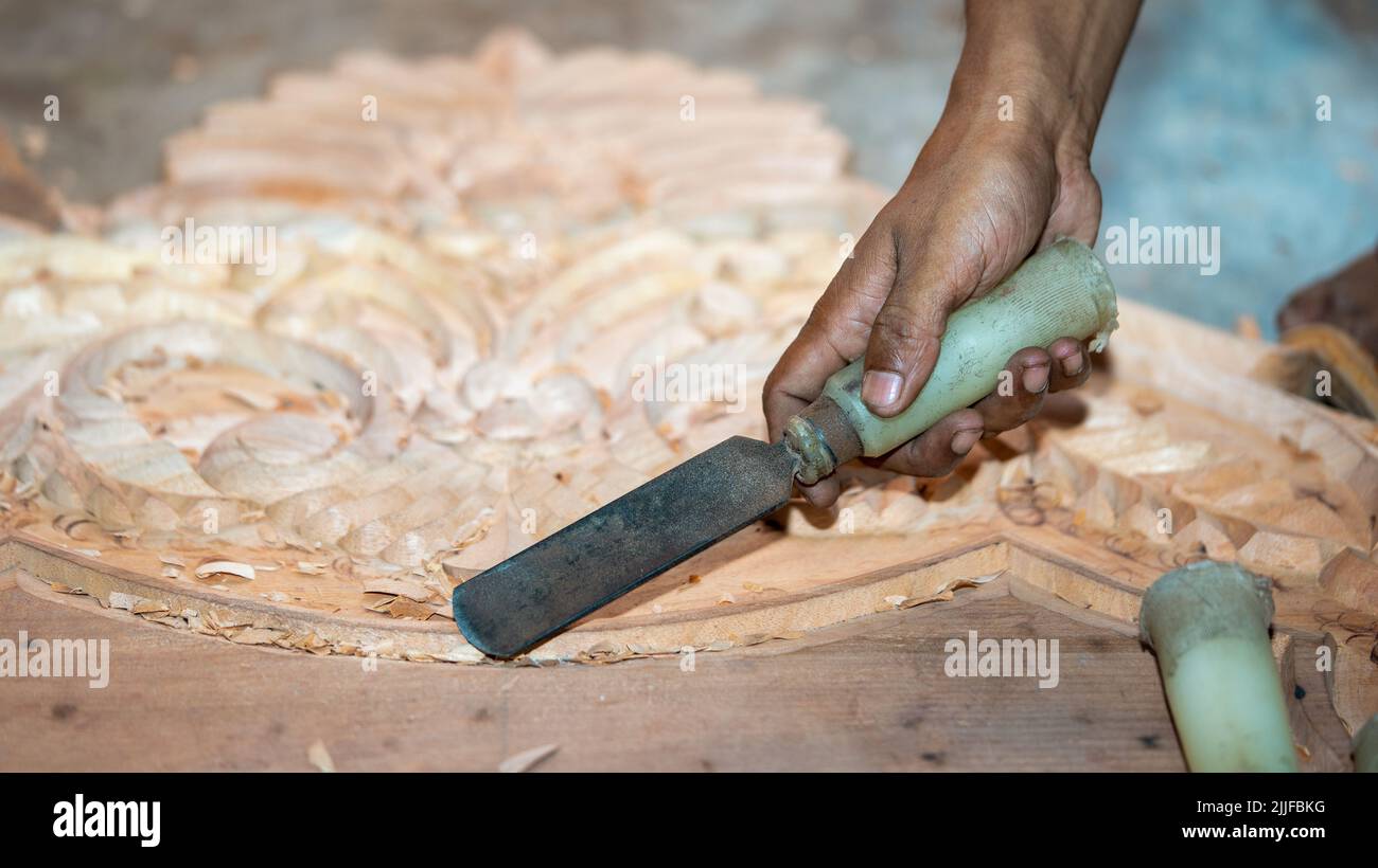 close-up carpenter man's hand treats the tree, cuts the shavings. Copy ...