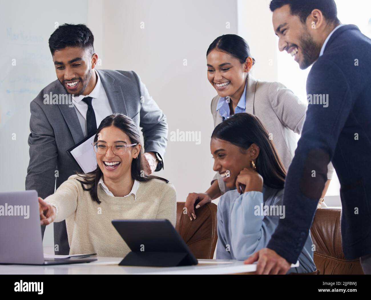 Everyone gets excited when a plan comes together. a group of colleagues laughing together Stock ...