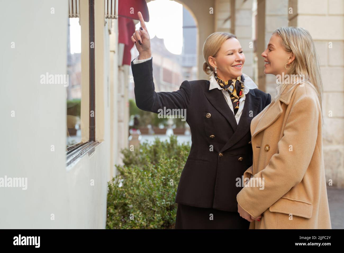 Businesswoman showing tourist attractions to a female guest Stock Photo ...