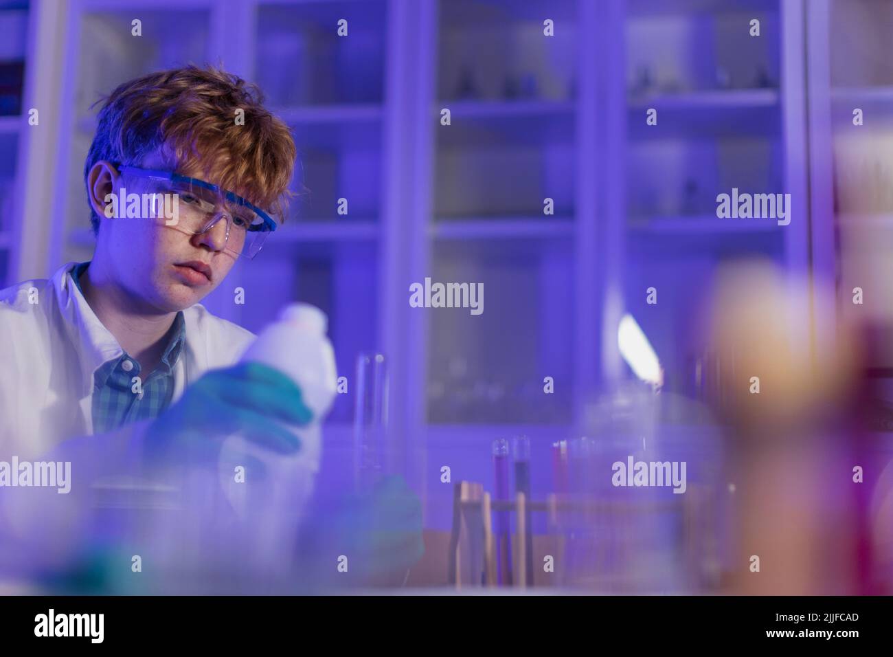 Science student doing chemical experiment in the laboratory at ...