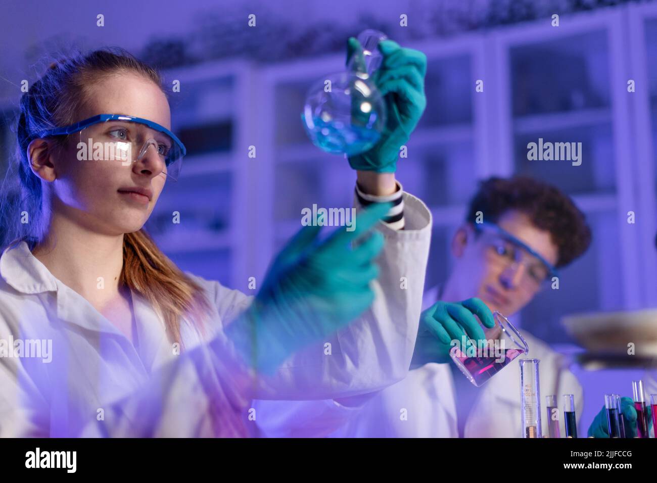 Science students doing chemical experiment in the laboratory at ...