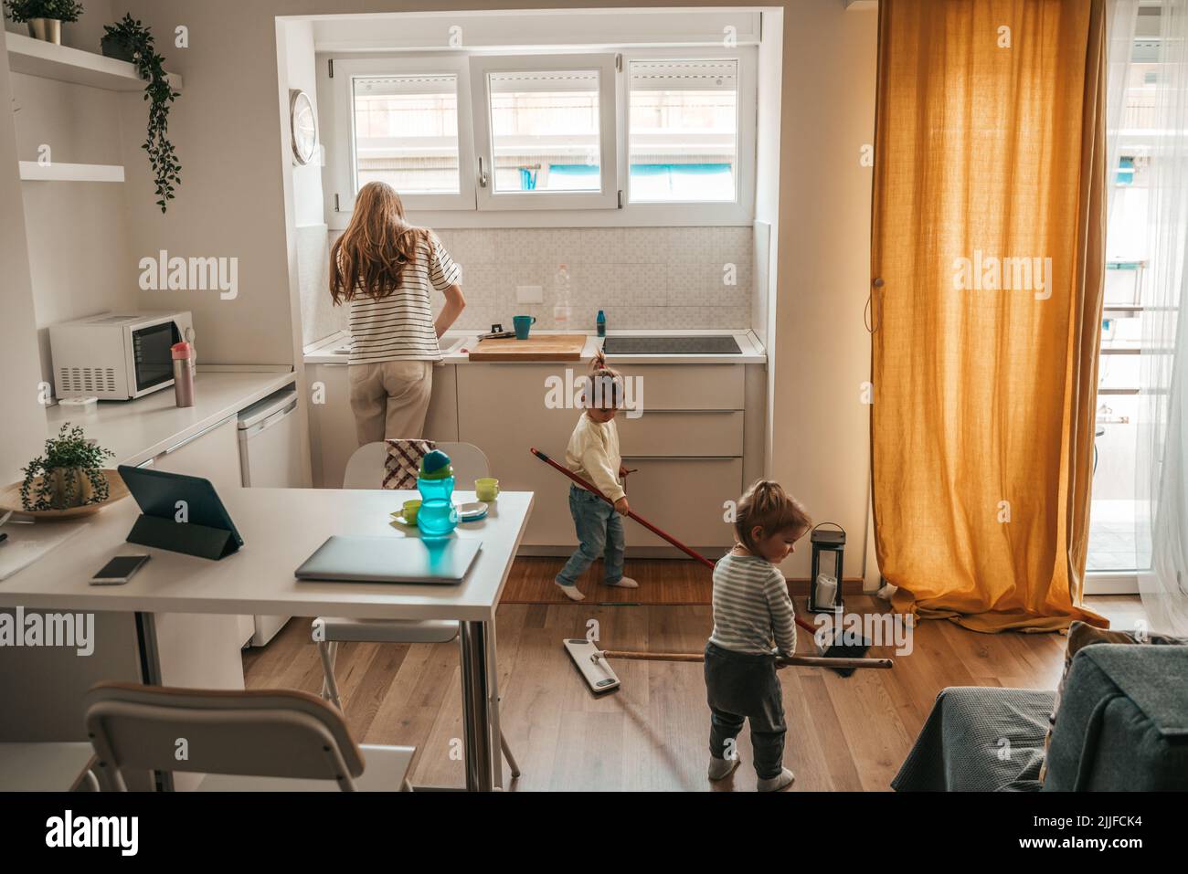 Family of three people doing housework together Stock Photo - Alamy
