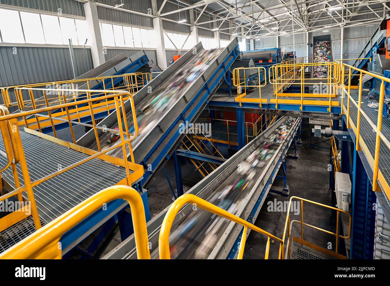 Conveyors carry trash and empty platforms at recycling plant Stock ...