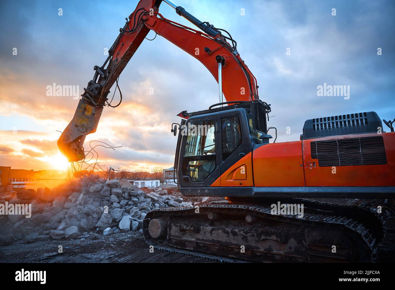 Excavator with concrete crusher on rig at demolition site Stock Photo ...