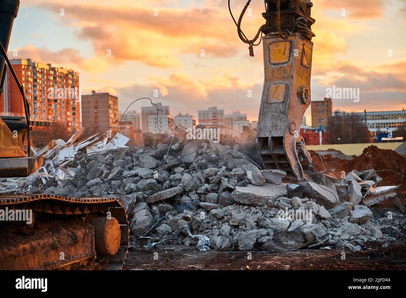 Crusher destroys reinforced concrete at demolition site Stock Photo - Alamy