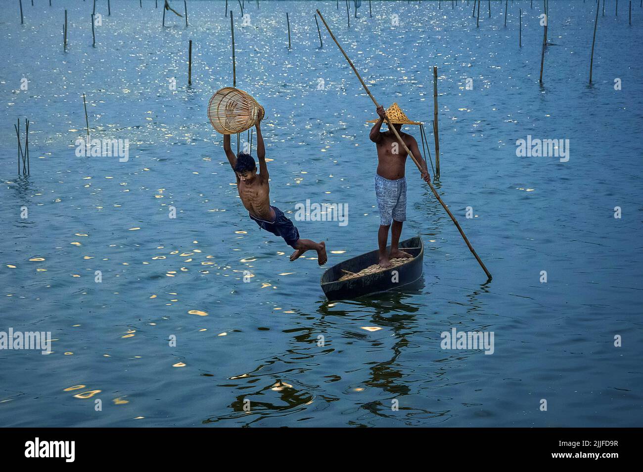 A young boy jumping to catch fish. West Bengal, India: IMAGES show the ...