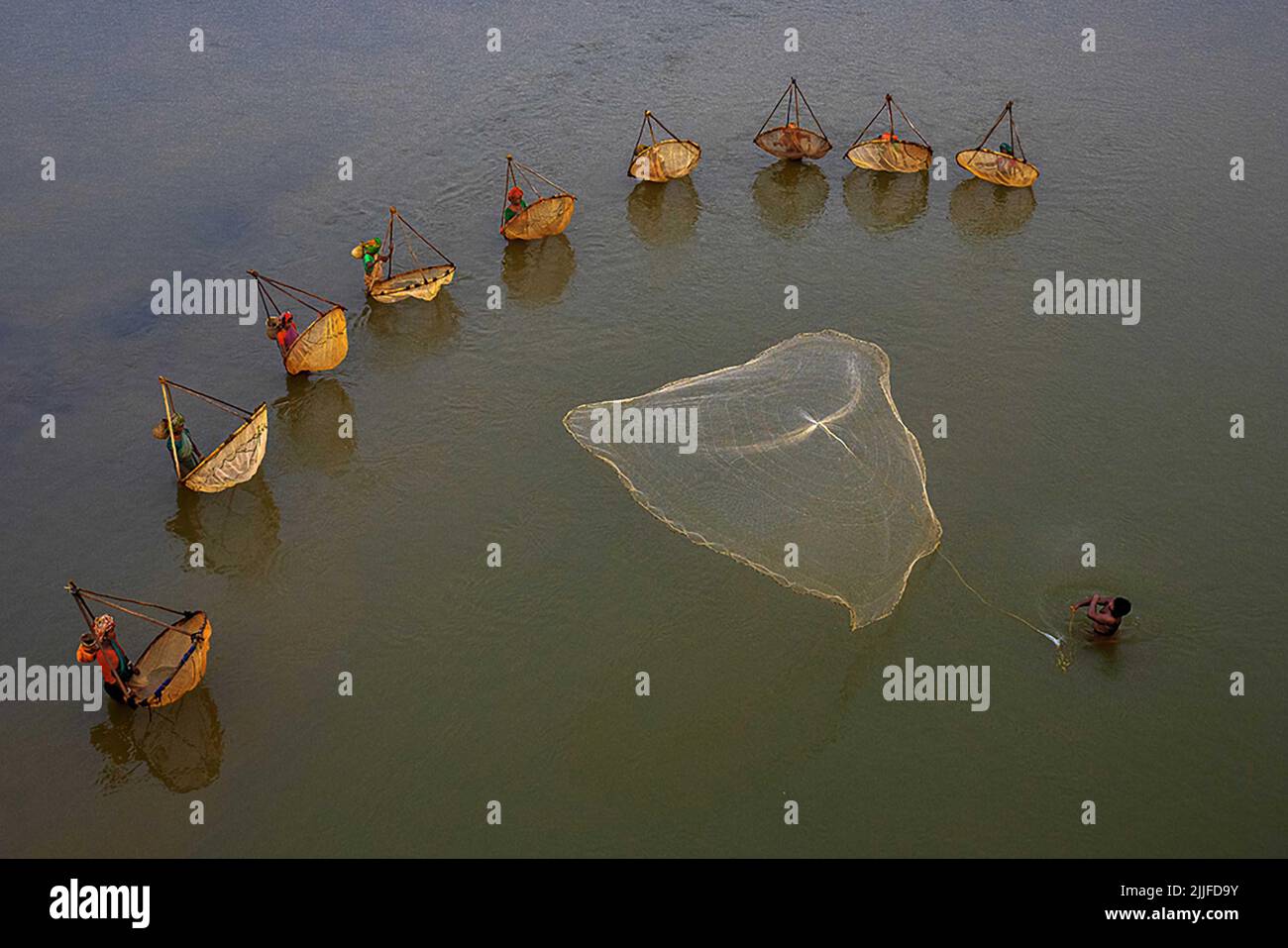 Fisherman handling their baskets. West Bengal, India: IMAGES show the ...