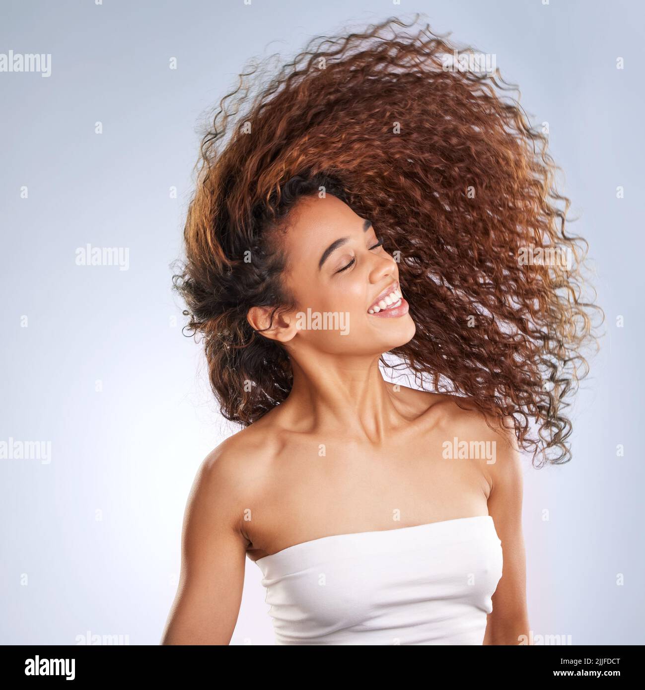 I whip my hair... an attractive young woman whipping her hair in studio ...