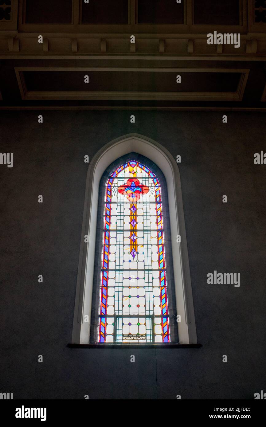 The interior of a church with a beautiful stained glass window Stock ...