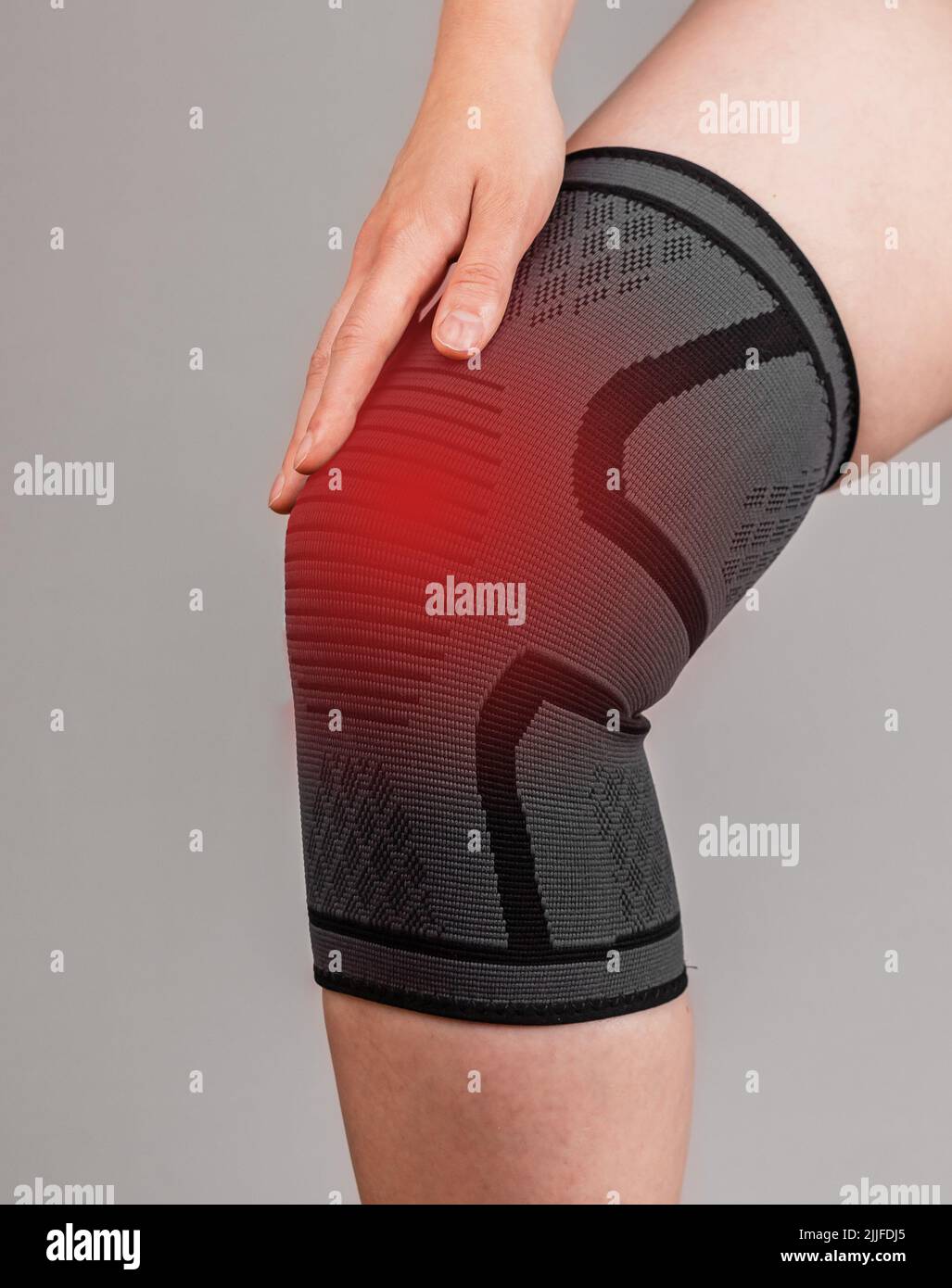 Woman wearing knee brace to reduce pain or prevent injury during sport ...