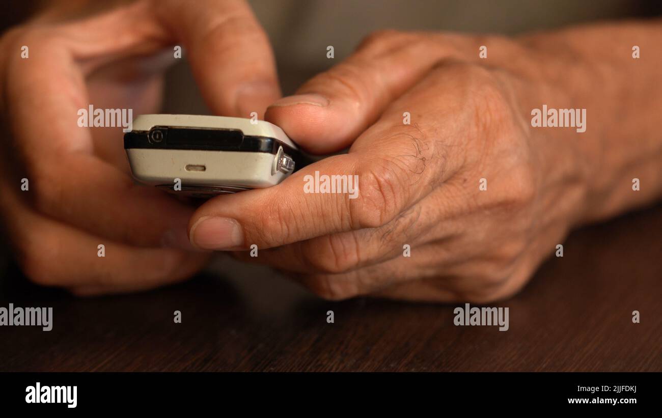 Old wrinkled hands holding mobile hi-res stock photography and images ...
