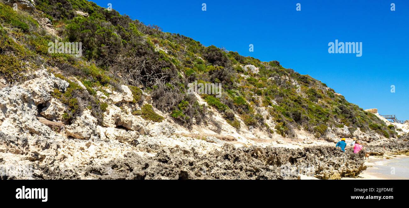 Two people walking Cape To Cape path along eroded limestone rocks Cape ...
