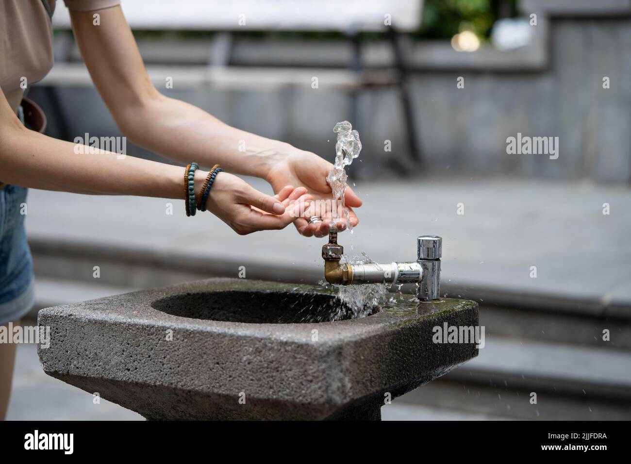 Girl hands in water fountain hi-res stock photography and images - Alamy