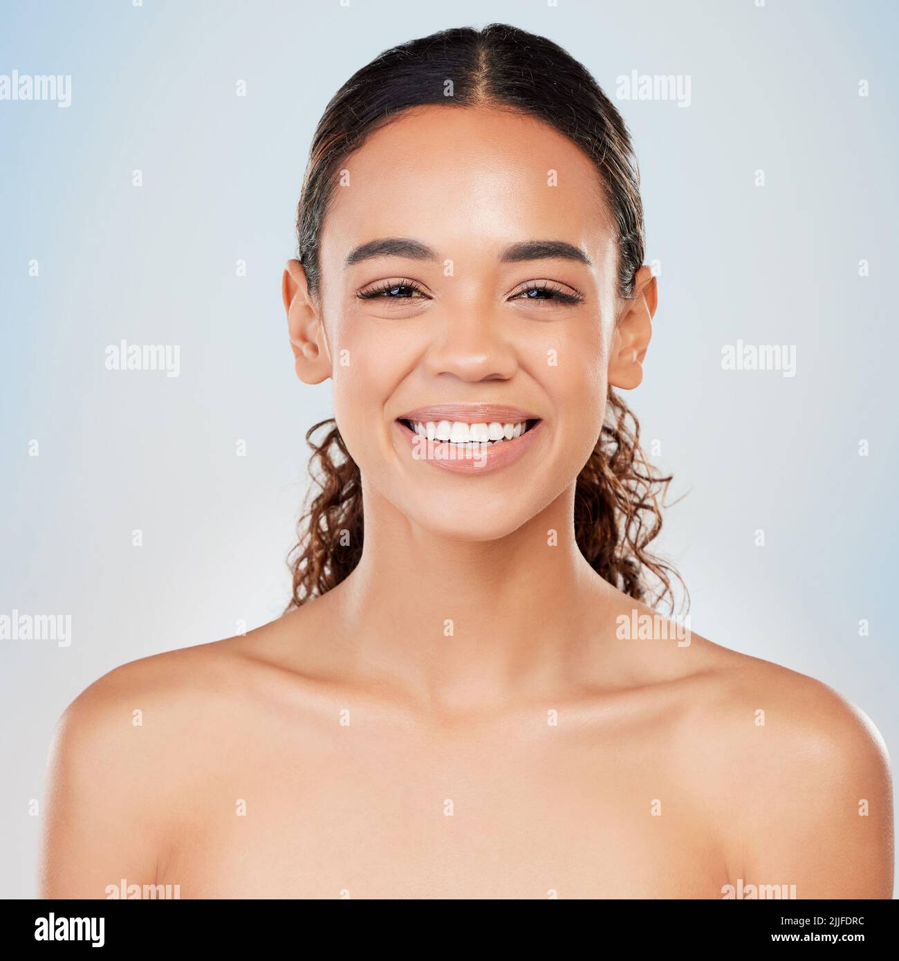 Nothing a smile cant fix. a young woman posing against a blue ...