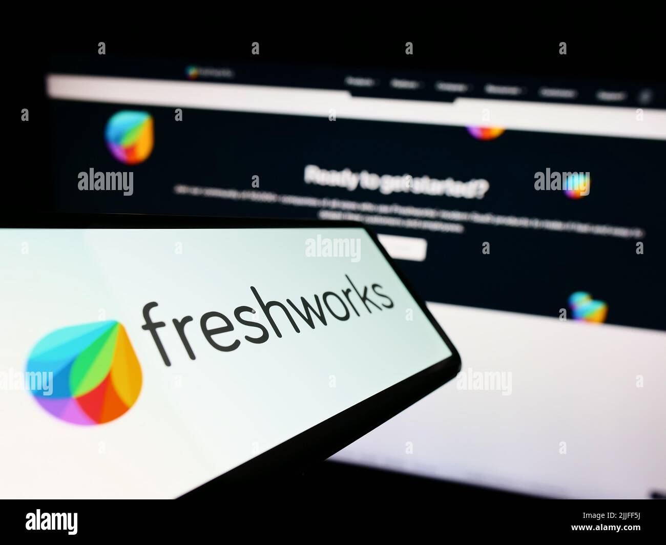 Cellphone with logo of software company Freshworks Inc. on screen in ...