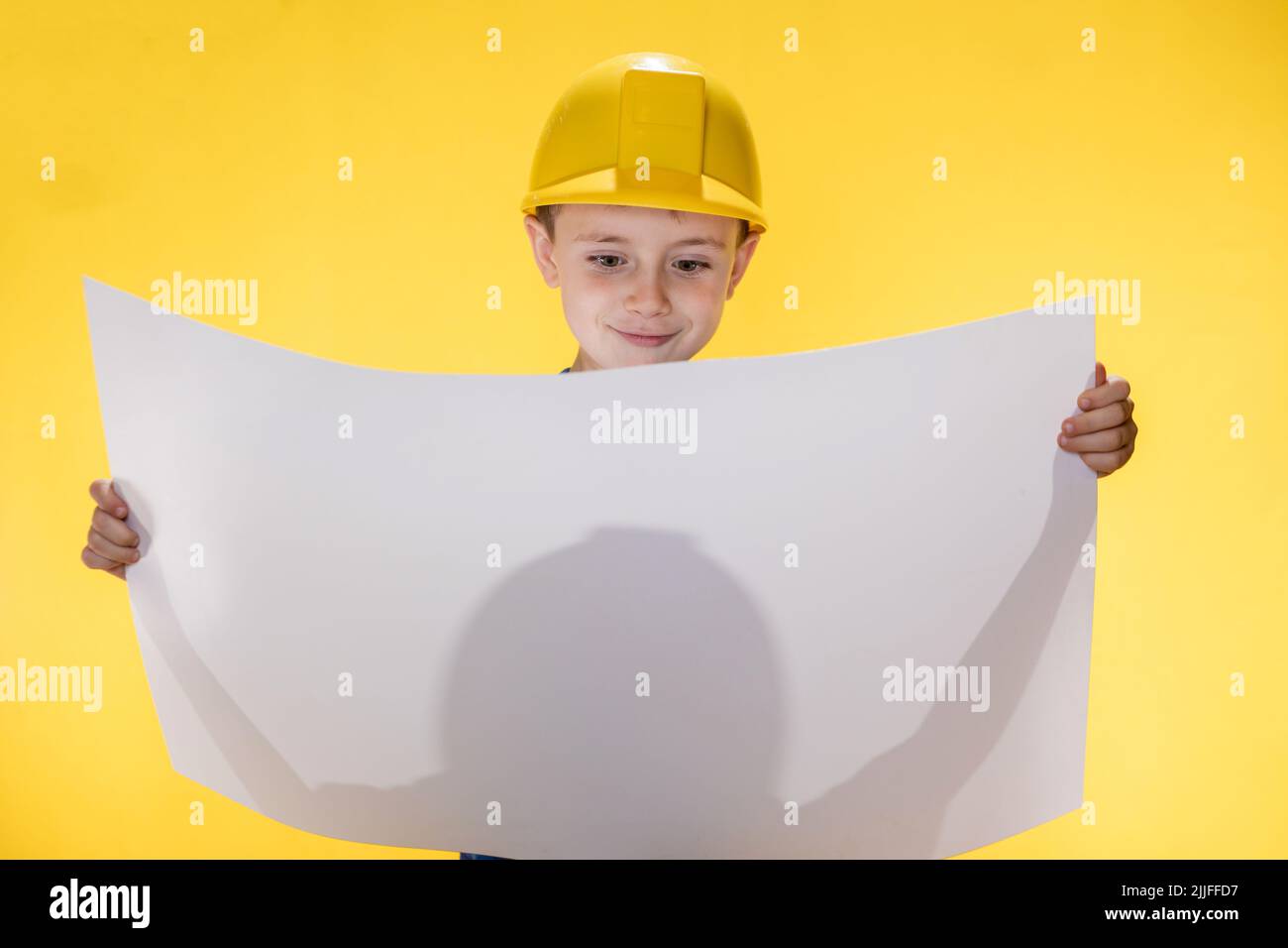A little boy holding plan project in his hands dreams of becoming a ...