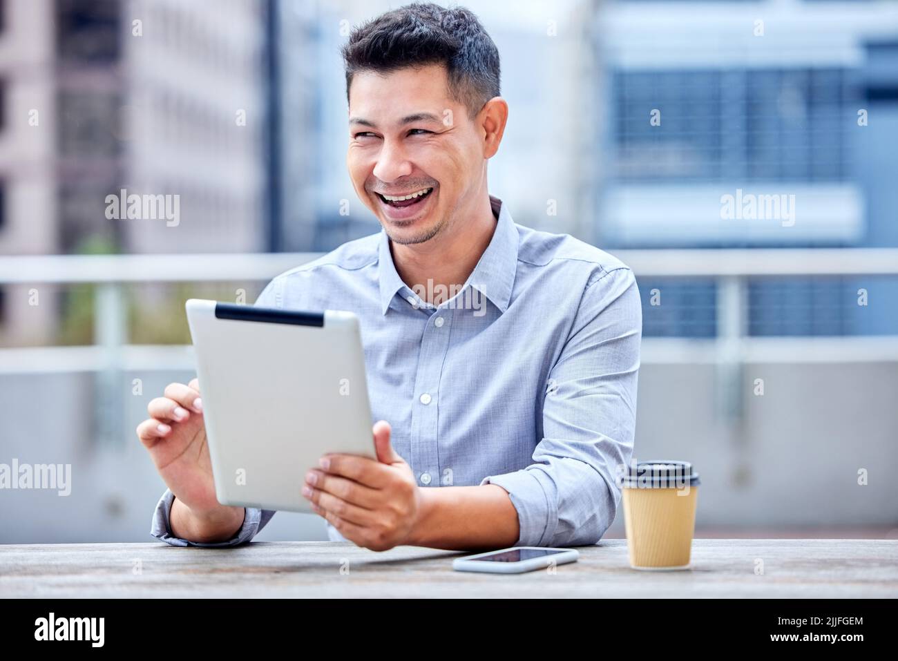 My tablet helps me with everything. a young businessman using a digital ...